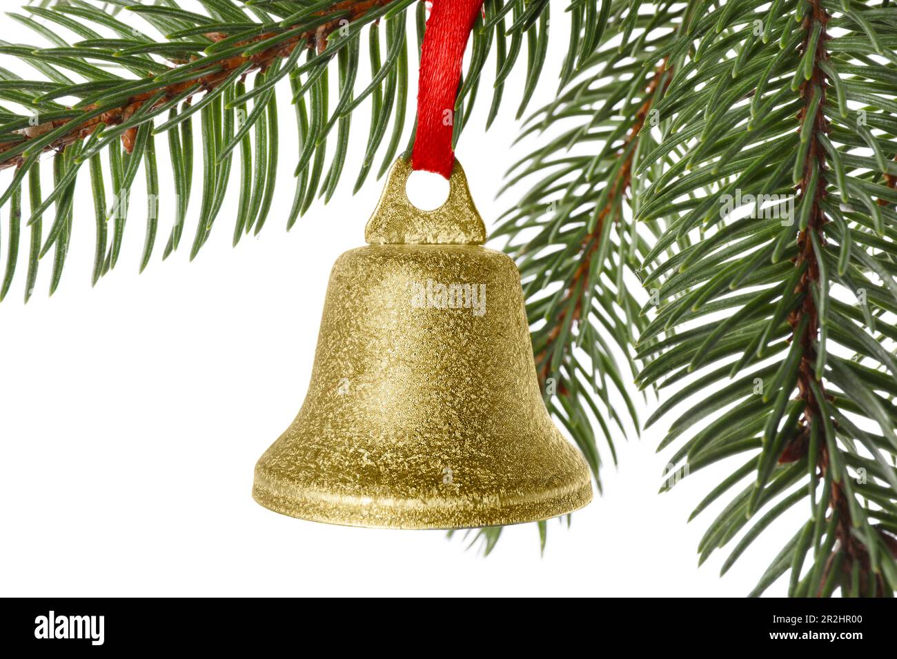 Christmas bell hanging on fir tree branch against white background ...