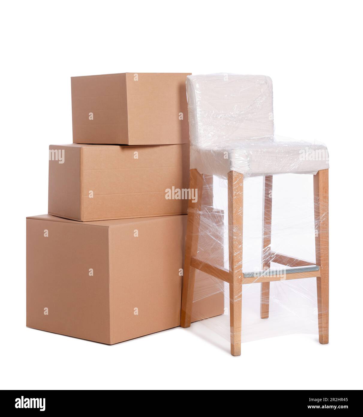 Chair wrapped in stretch film and boxes on white background Stock Photo ...