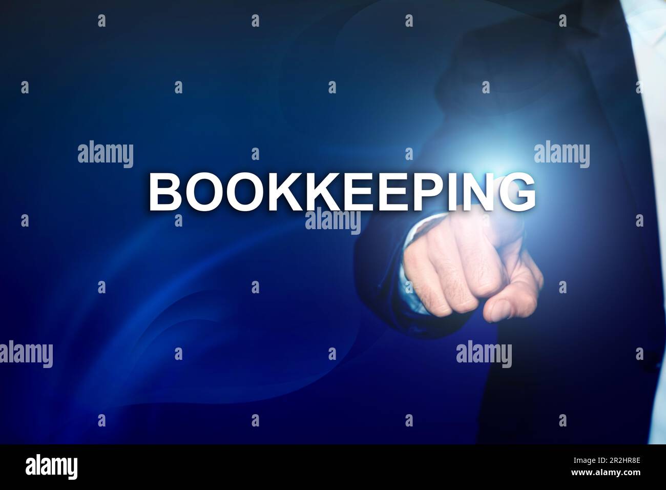 Bookkeeping concept. Businessman pointing at word on dark blue ...