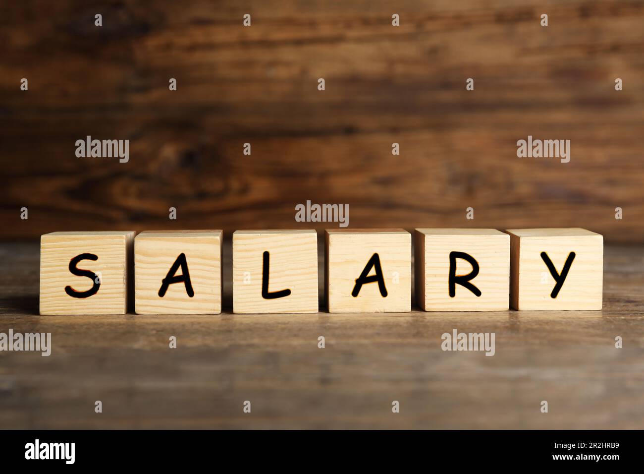 Word Salary made with cubes on wooden table Stock Photo - Alamy