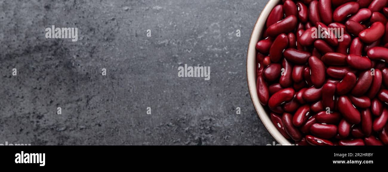 Red kidney beans in bowl and space for text on grey table, top view ...