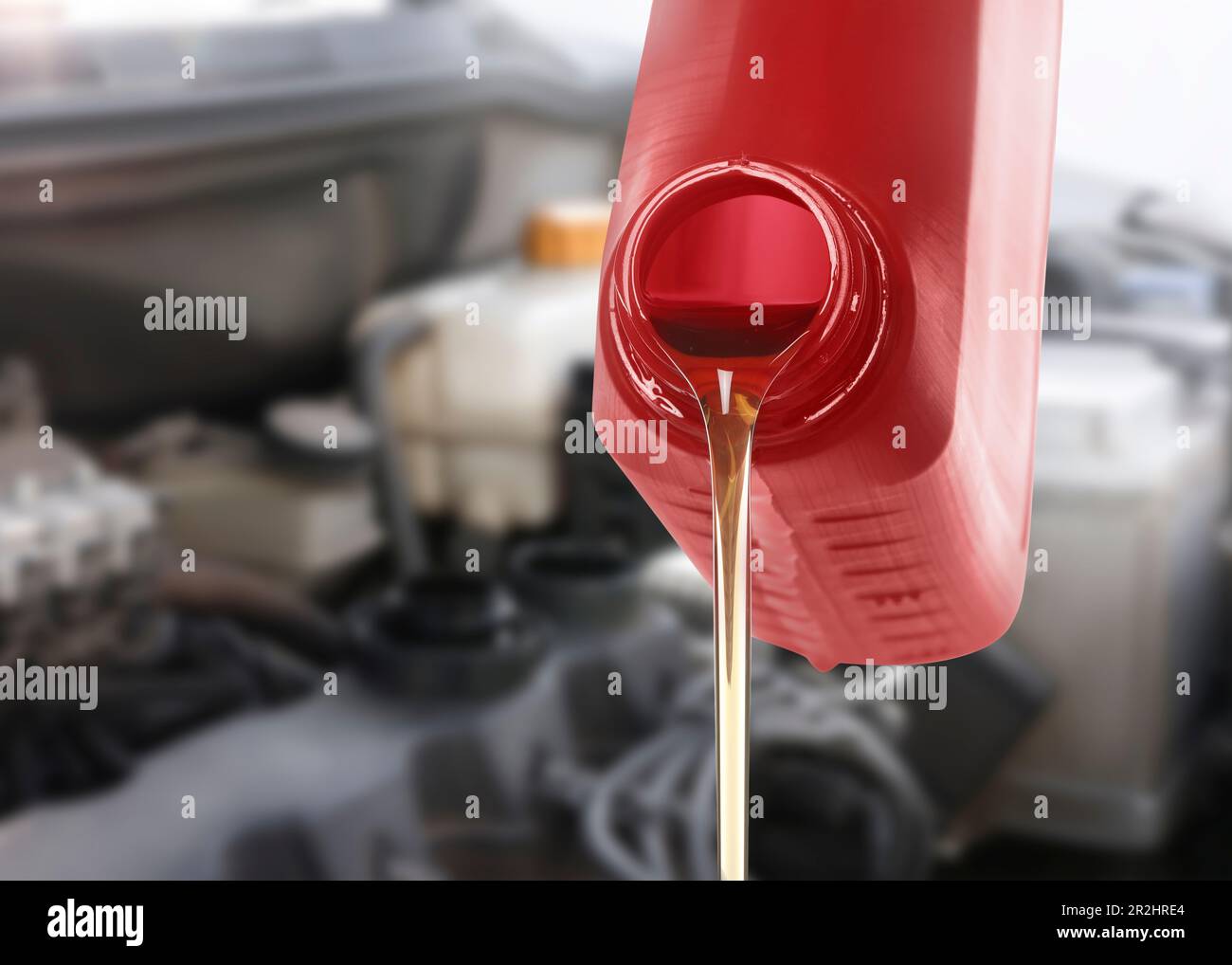 Pouring motor oil from red container, closeup Stock Photo - Alamy