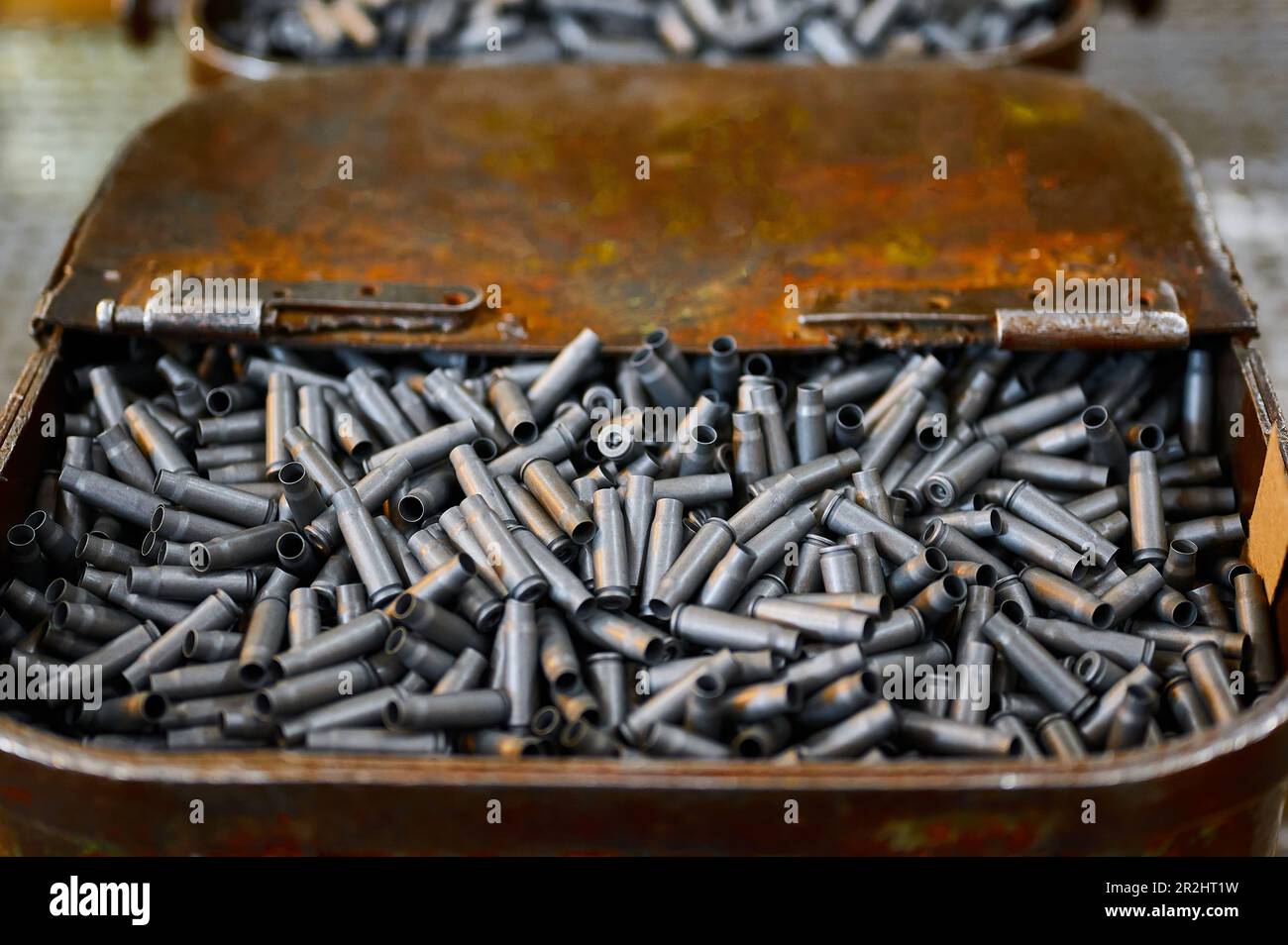 Metal containers full of bullet casings on table at plant Stock Photo ...