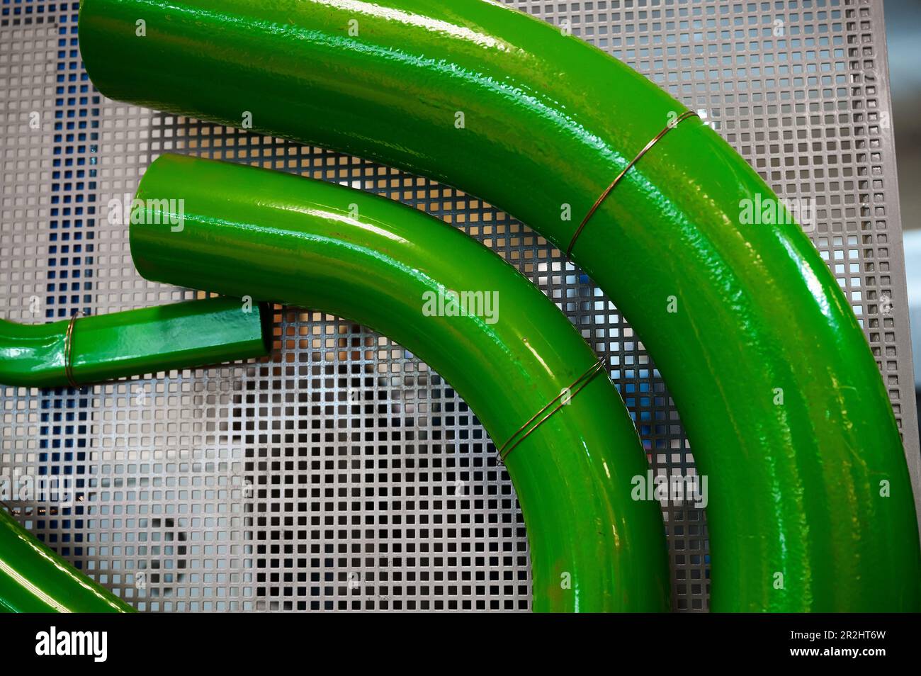 Metal pipe samples covered with green paint in store Stock Photo - Alamy