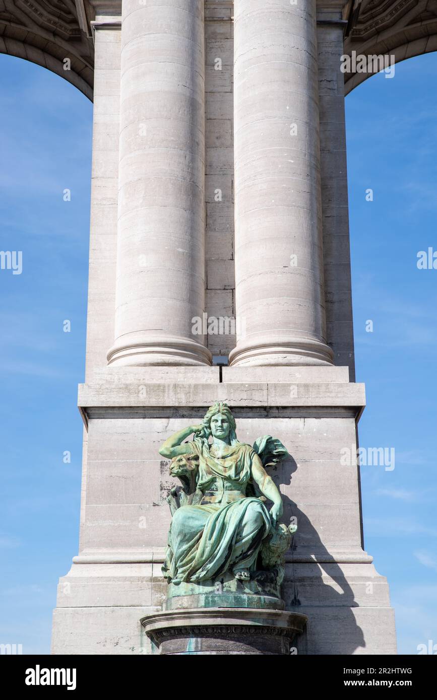 Statue sitting at bottom of column at the Monument du Cinquantenaire in ...
