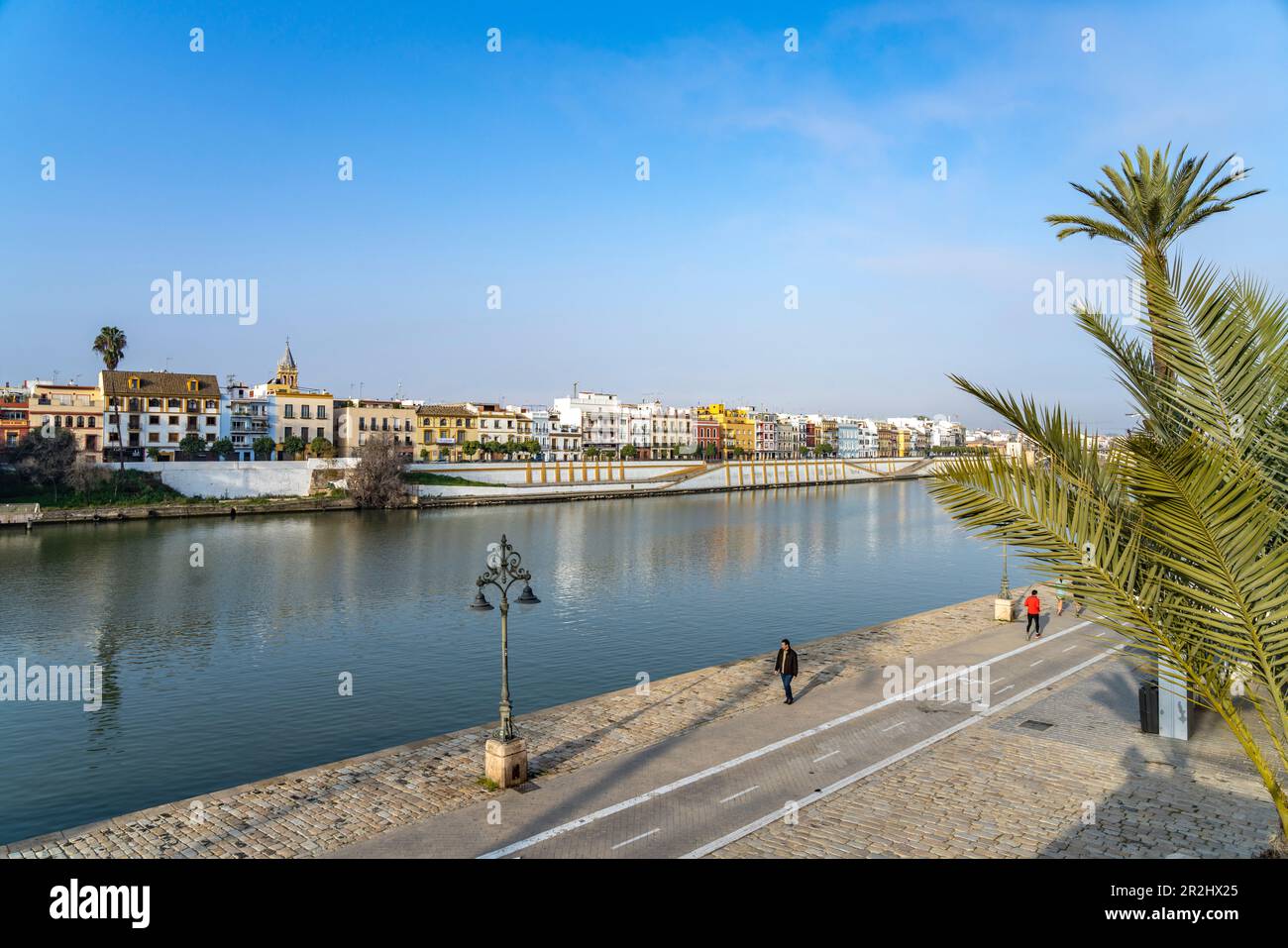 Waterfront promenade and the colorful houses of the Triana district on ...