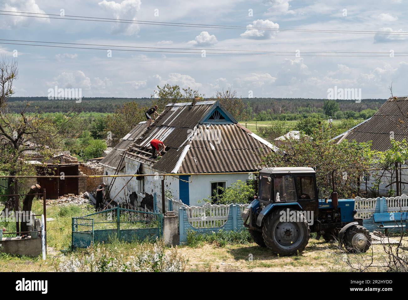 People seen rebuilding destroyed house of village Velyka Oleksandrivka ...