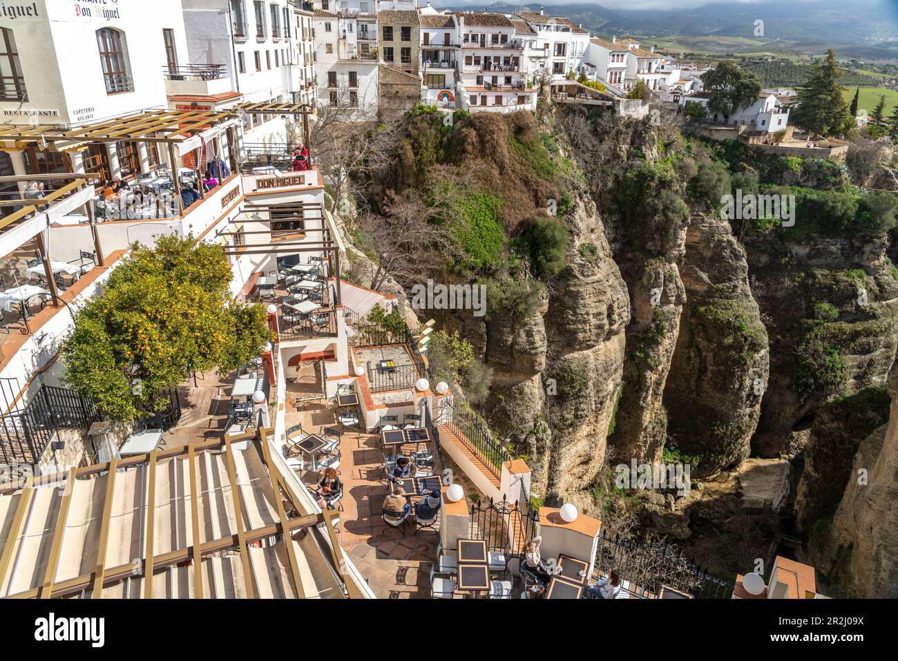 Restaurants high above Tajo de Ronda Gorge and the white houses of La ...