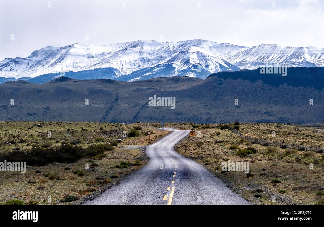 Highway leading to snow covered mountains, Torres del Paine National ...