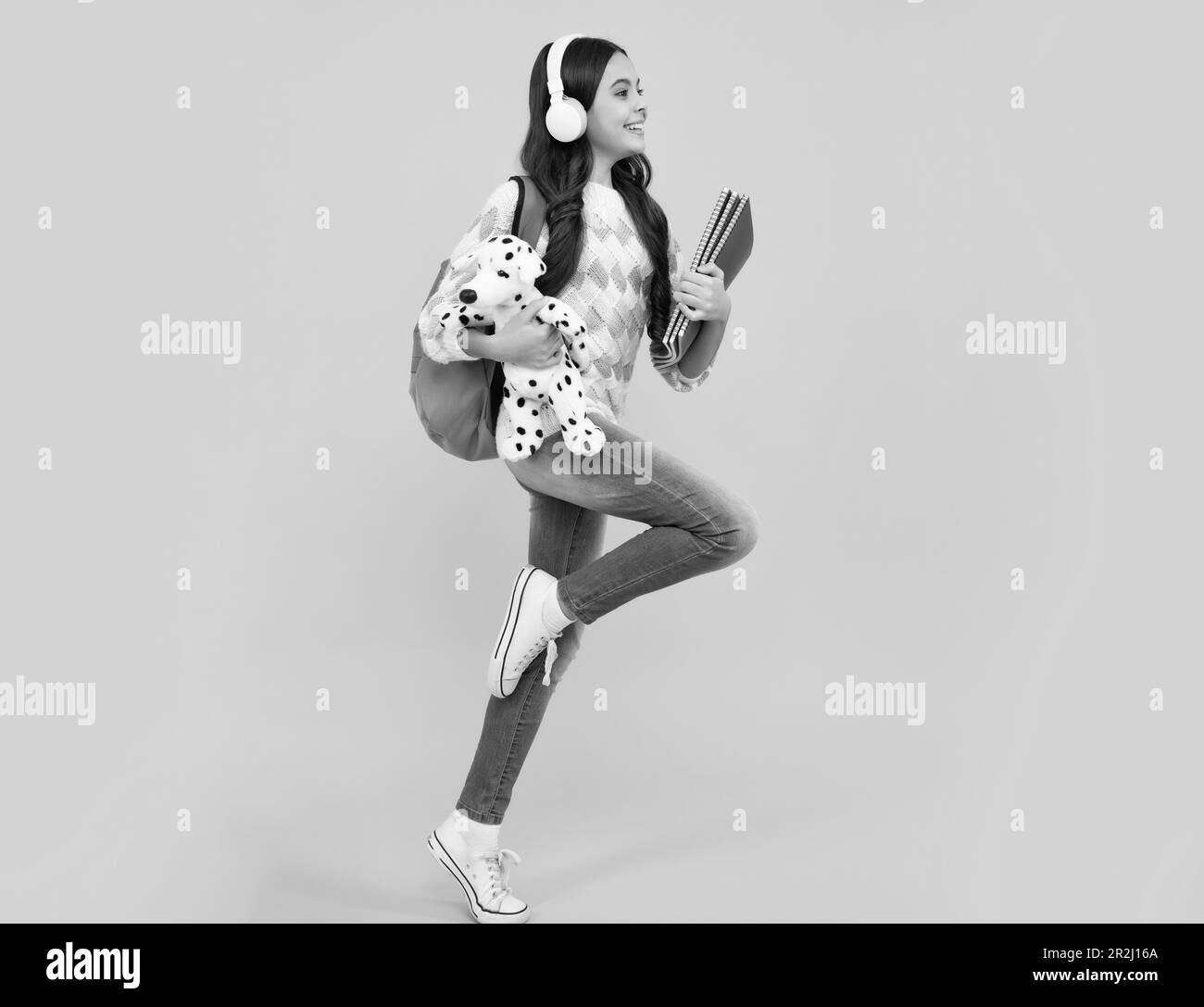 Back to school. Teenager schoolgirl hold book with toy ready to learn ...