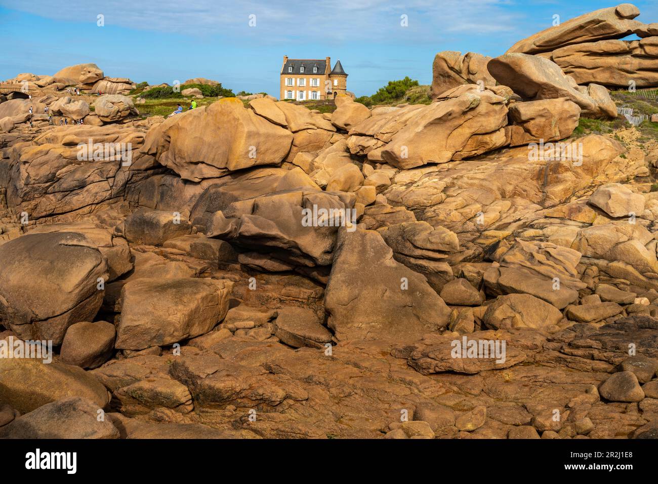 The rocks of the pink granite coast Côte de Granit Rose and Maison Gustave Eiffel at Ploumanac'h ...