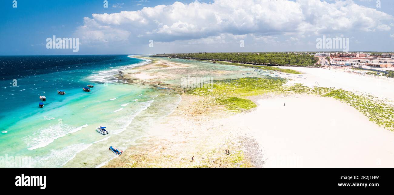 Boats moored in the turquoise waters of the Indian Ocean overlooking an ...