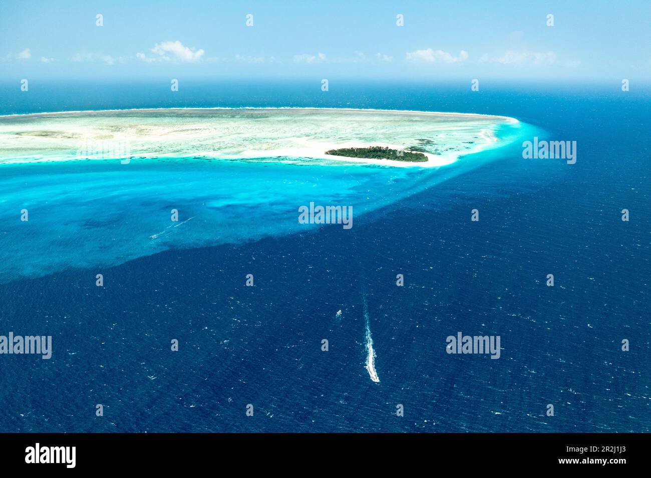 Aerial view of idyllic tropical island washed by the blue Indian Ocean ...