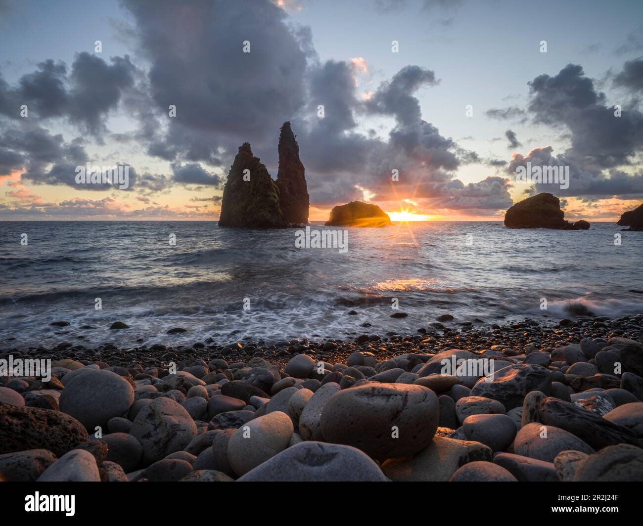 Sunrise below sea stacks from the pebble beach of Bahia da Alagoa ...