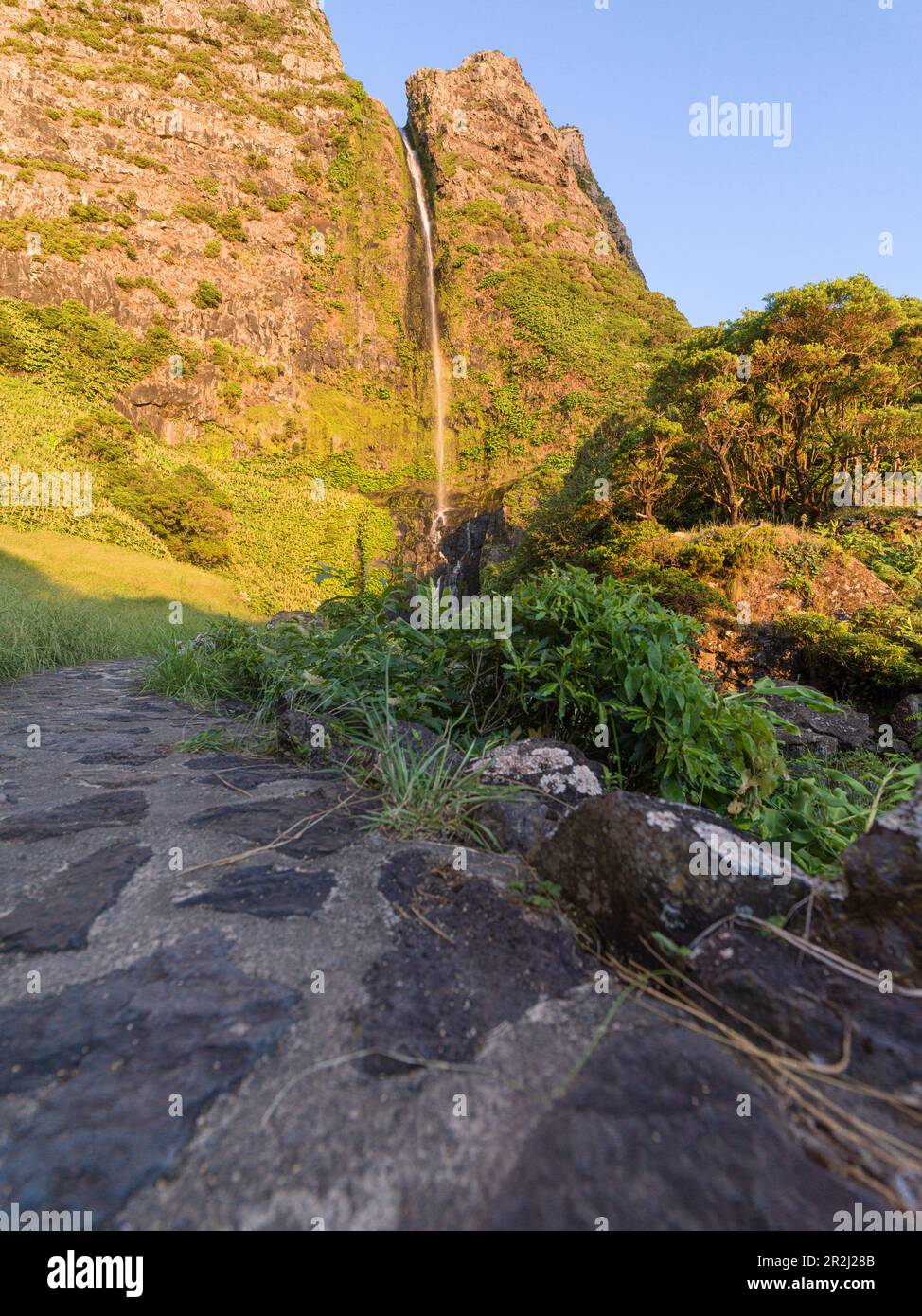 Waterfall, Poco do Bacalhau, at sunset on Flores island, Azores Islands ...