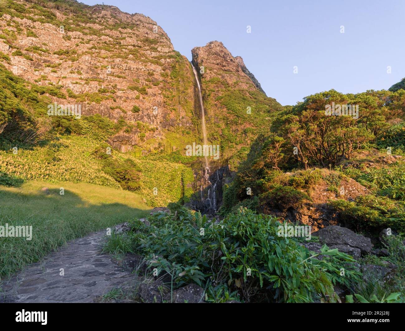 Waterfall, Poco do Bacalhau, at sunset on Flores island, Azores Islands ...