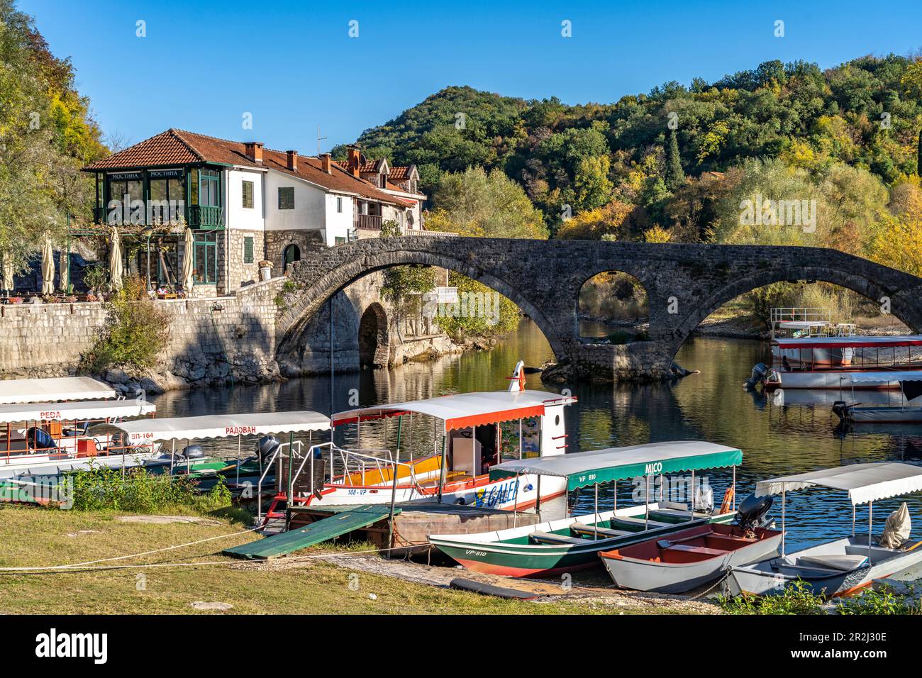 Excursion boats on the Old Bridge Stari Most over the Crnojevic River in Rijeka Crnojevica ...
