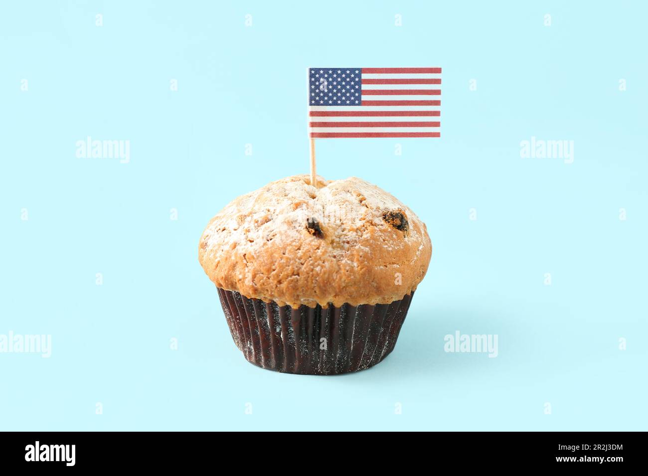 Tasty muffin with paper American flag on color background. Memorial Day ...