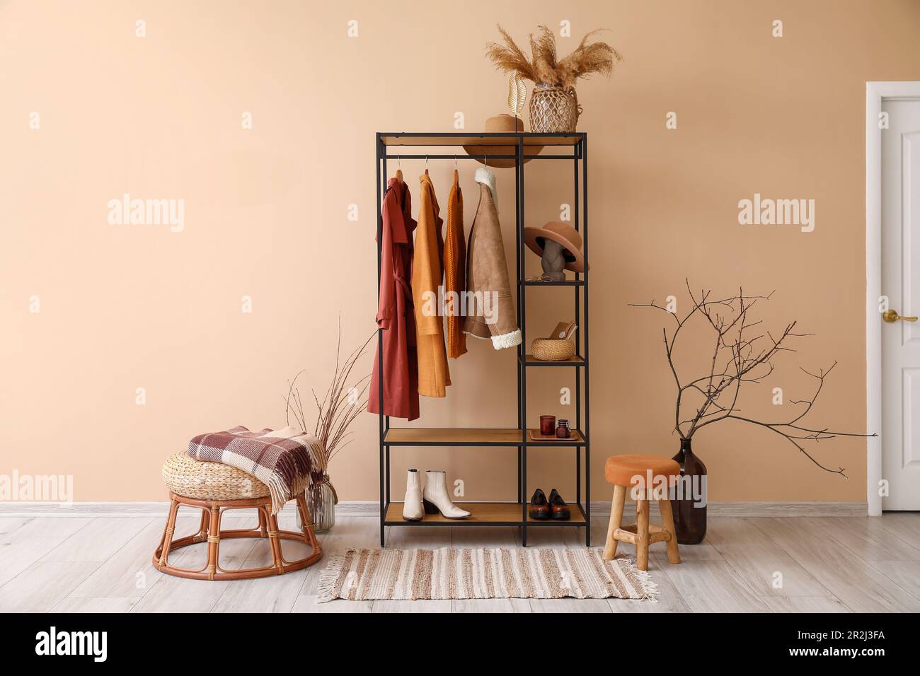 Interior of hall with shelving unit, clothes and shoes Stock Photo - Alamy