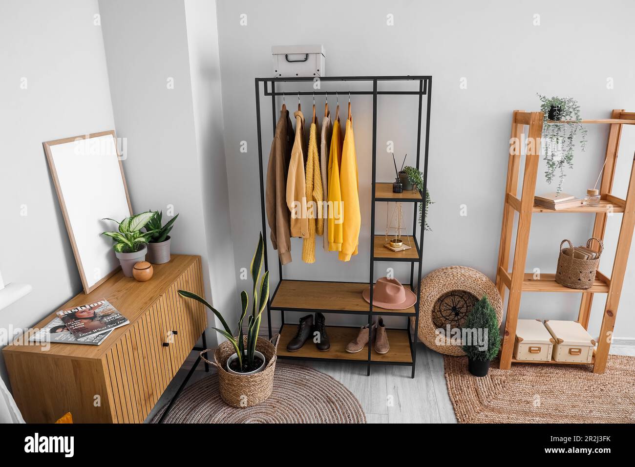 Interior of living room with shelving unit and clothes Stock Photo - Alamy