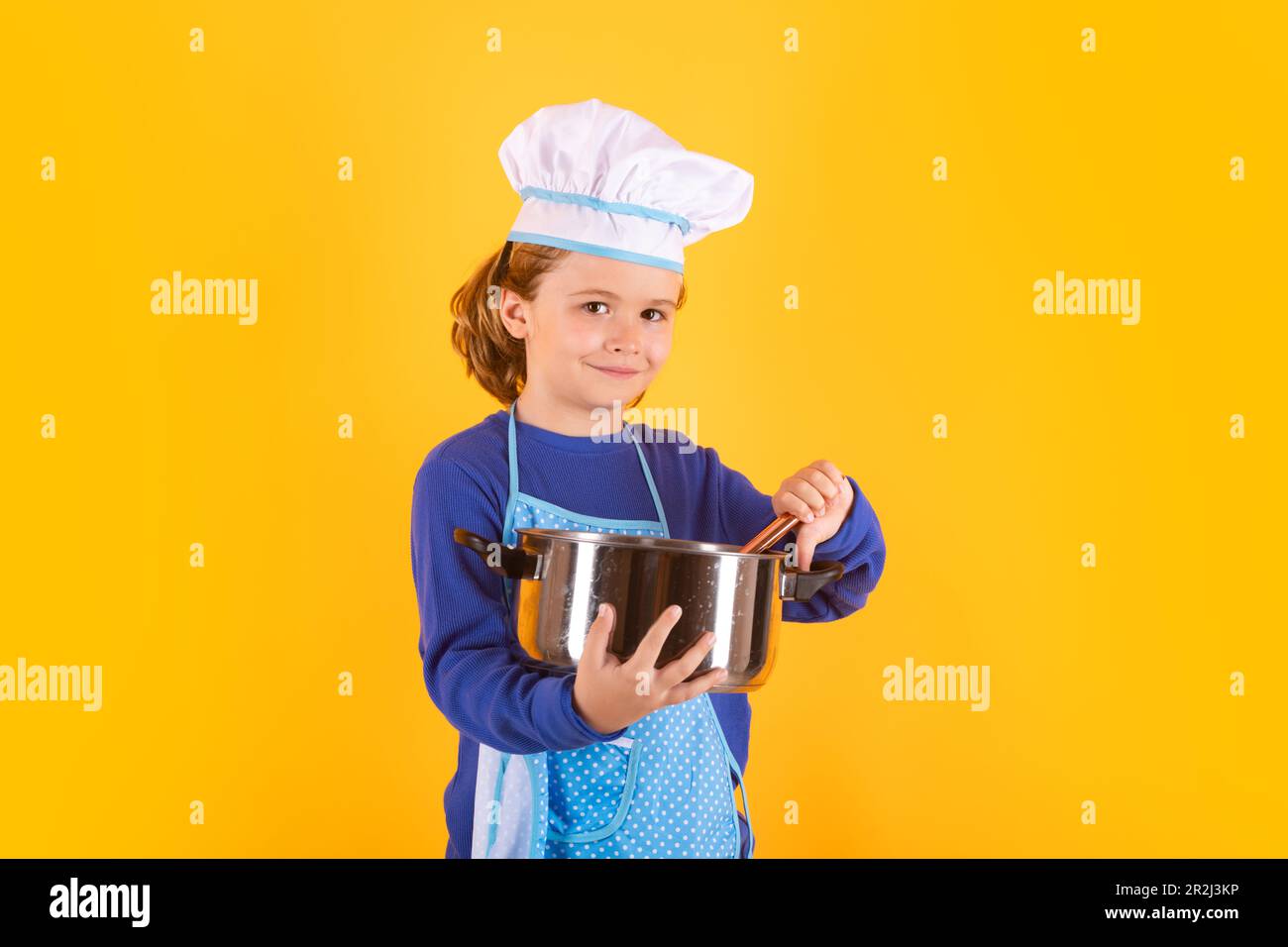 Kid cook with cooking pot and ladle. Child chef cook prepares food on ...
