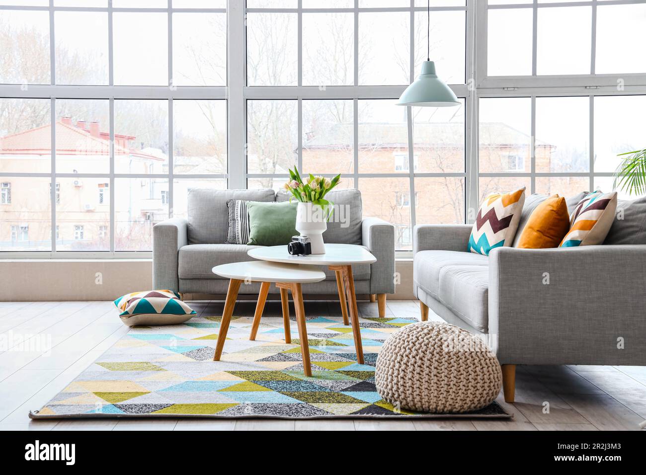 Interior of bright living room with cozy sofas and coffee table near ...