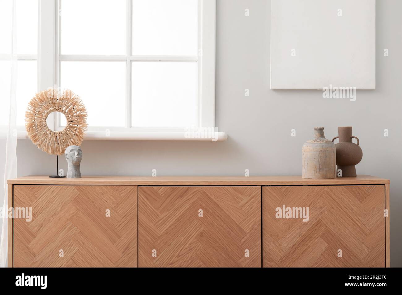 Stylish wooden cabinet near window Stock Photo - Alamy