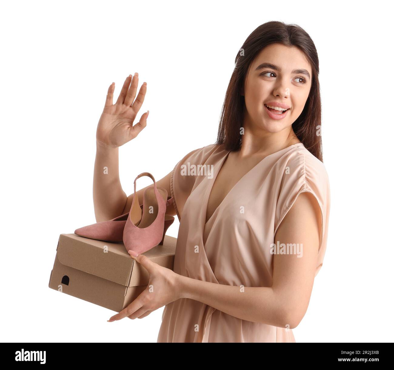 Young woman with shoe box waving hand on white background Stock Photo ...