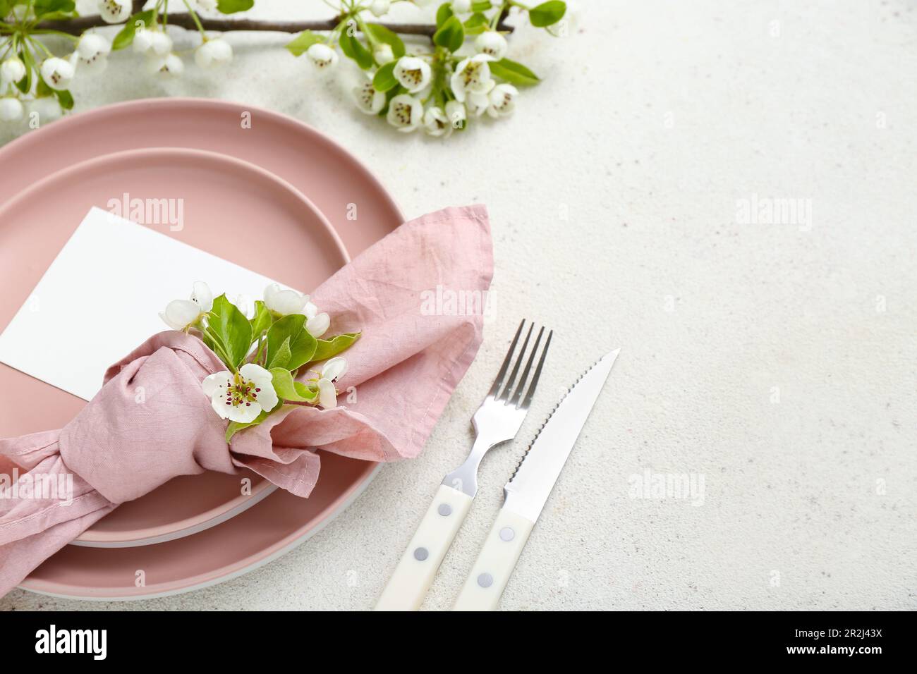 Beautiful table setting with blooming tree branches and blank ...