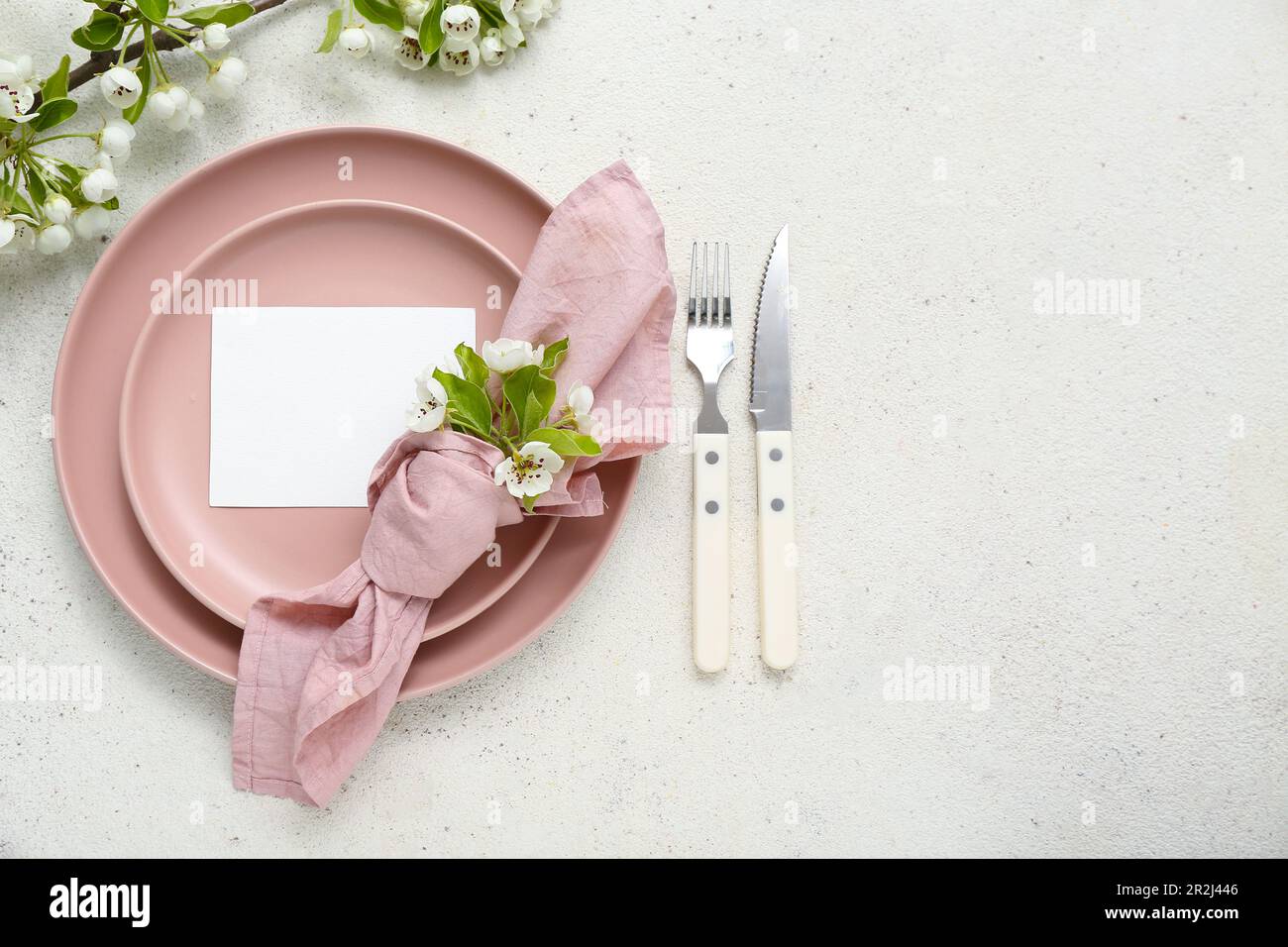 Beautiful table setting with blooming tree branches and blank ...