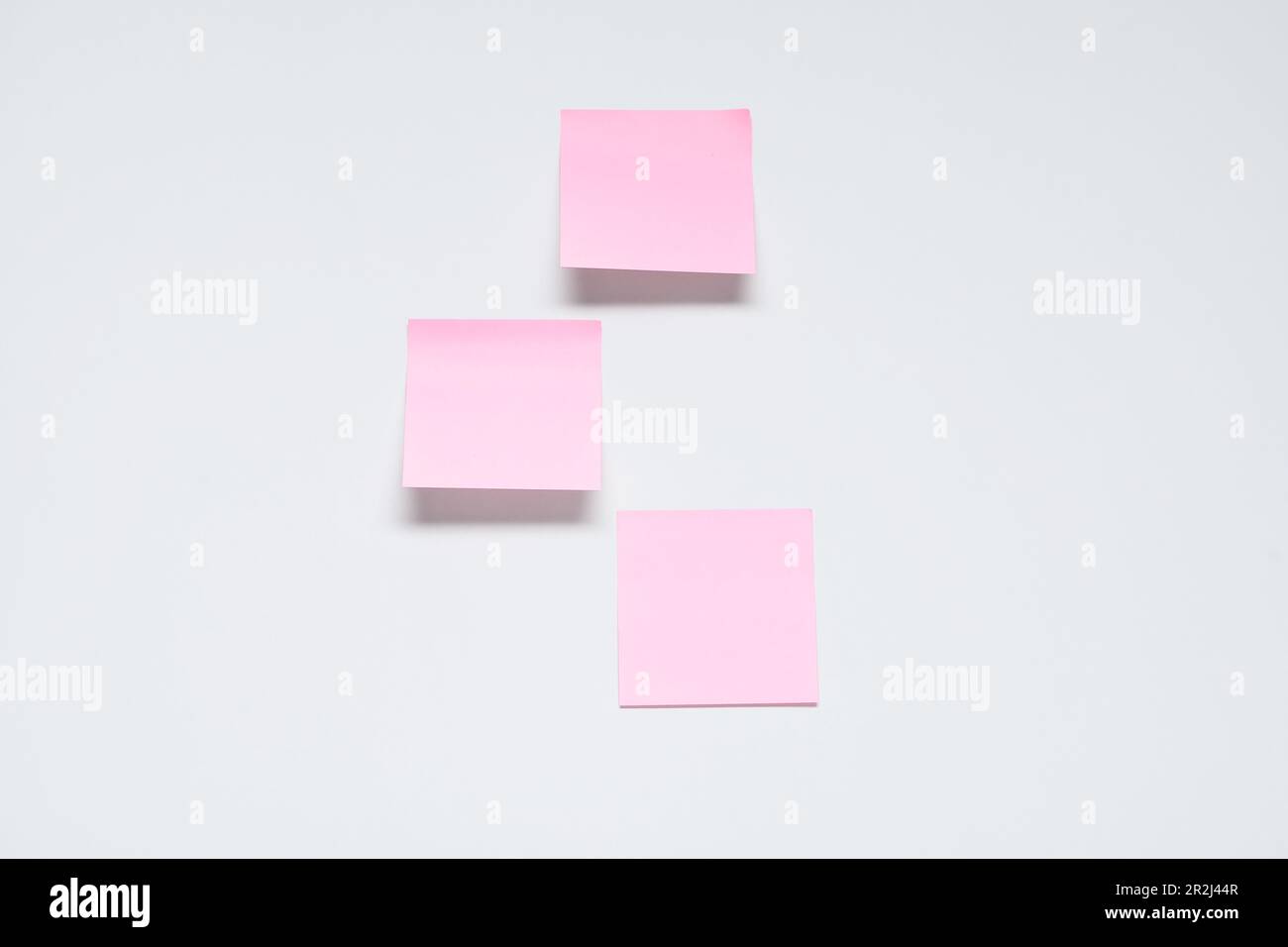 Pink sticky notes on grey background Stock Photo - Alamy