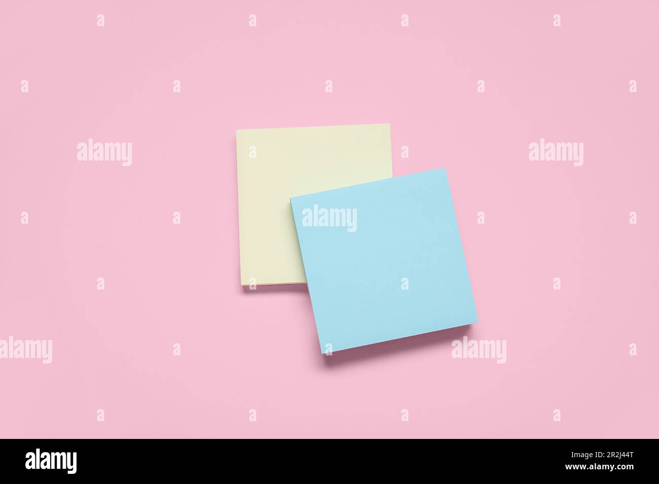 Sticky notes on pale pink background Stock Photo - Alamy