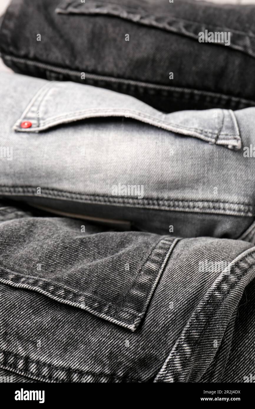 Different folded denim jeans as background, closeup Stock Photo - Alamy