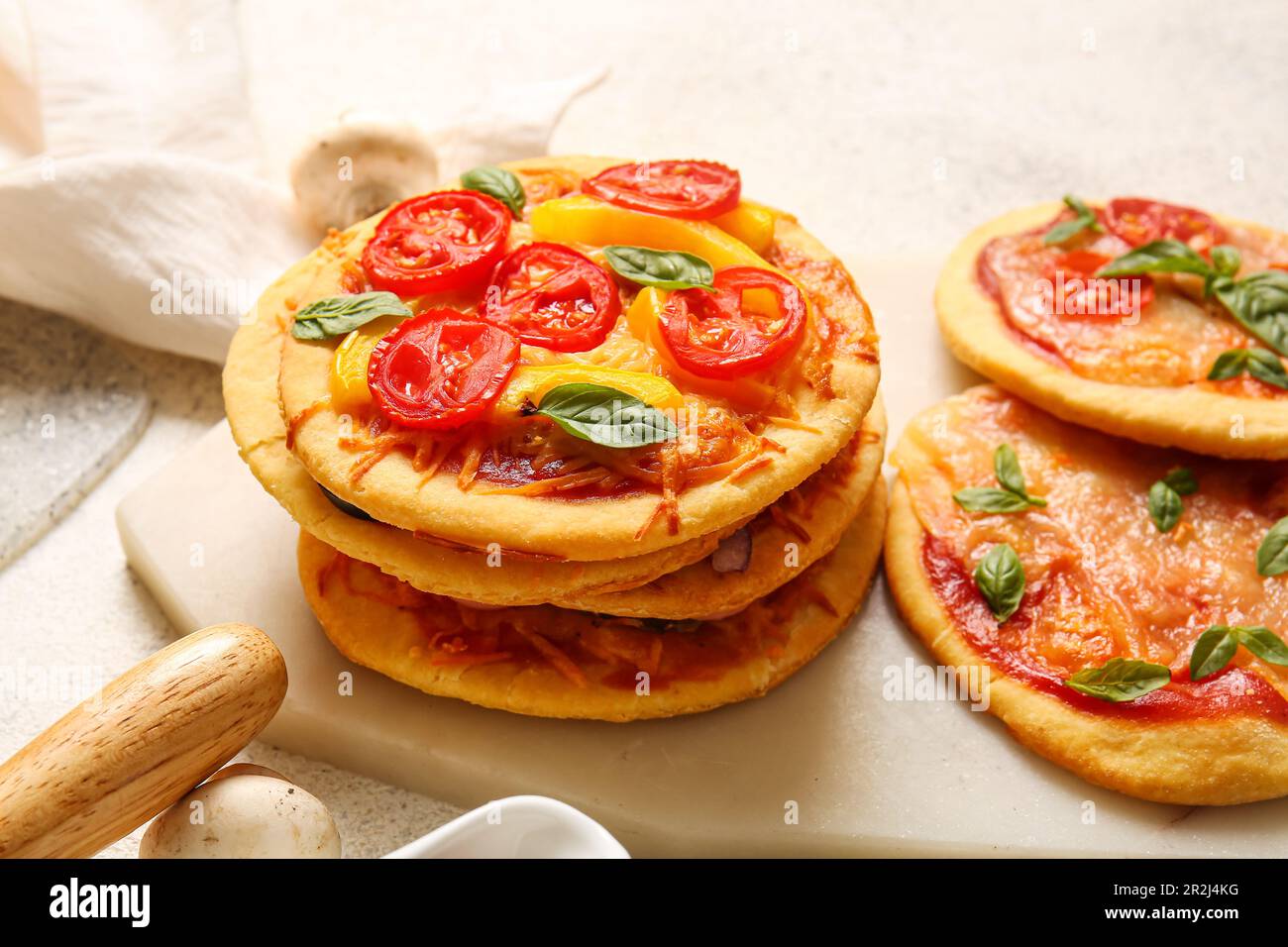 Board with different tasty mini pizzas on white background Stock Photo ...