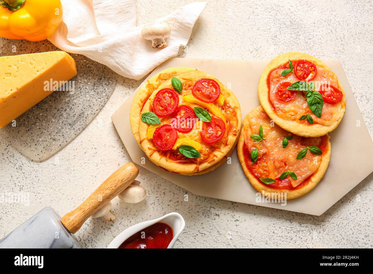 Board with different tasty mini pizzas on white background Stock Photo ...