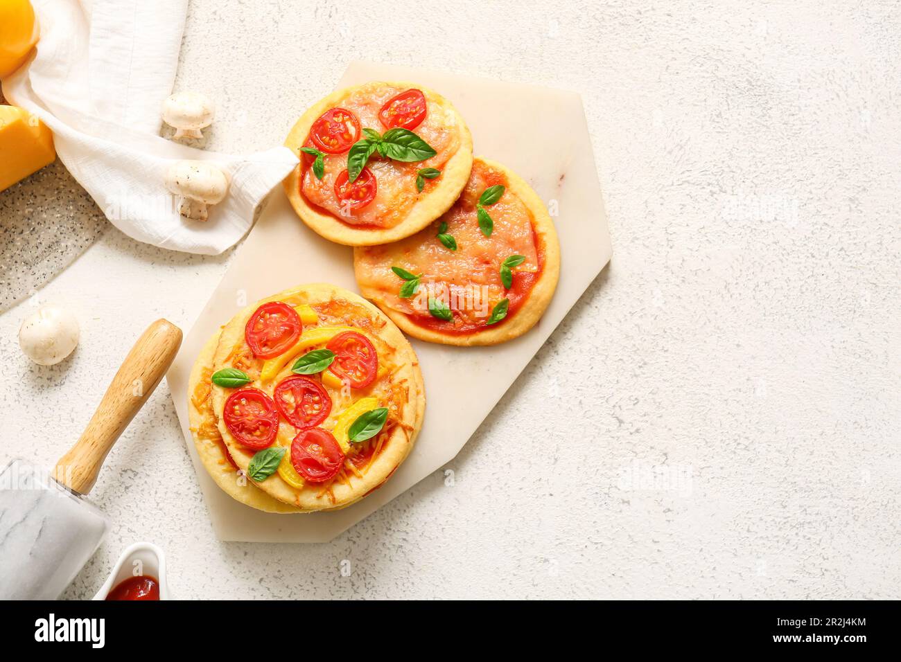 Board with different tasty mini pizzas on white background Stock Photo ...