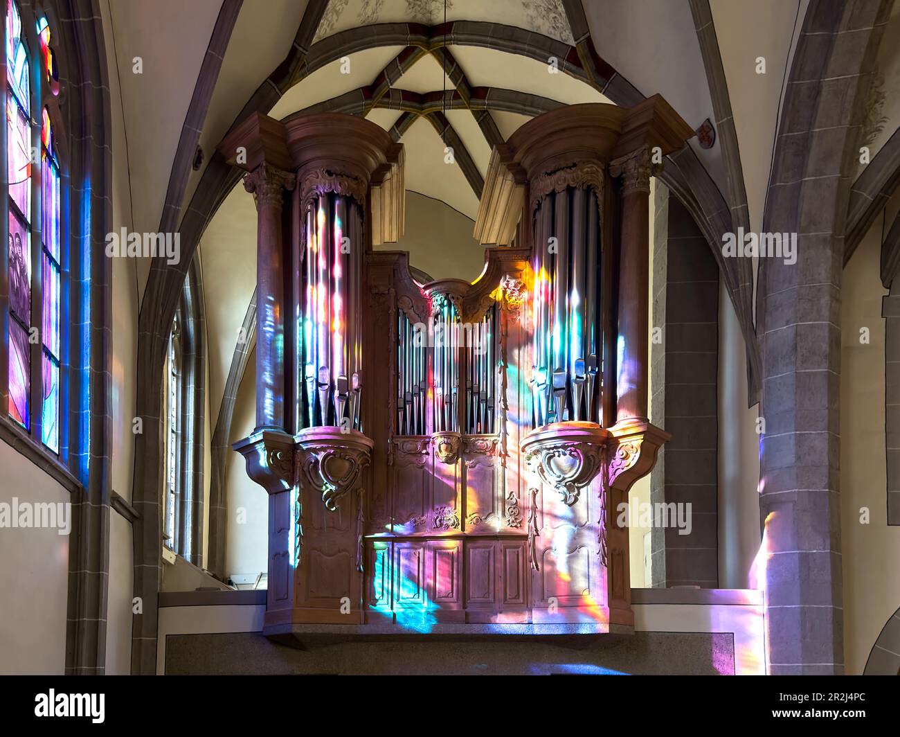 Organ prospectus of a historic portal organ in the sun shining through ...
