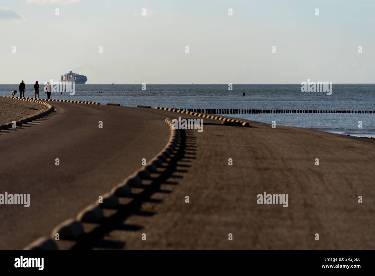 People walking by the North Sea in the province of Zeeland in the ...