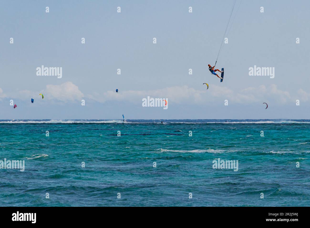 A kitesurfer in flight far above the sea, Le Morne, Mauritius, Indian ...