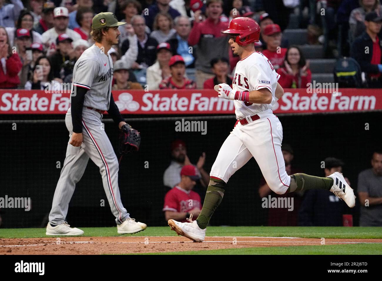 Los Angeles Angels' Zach Neto, right, scores on a sacrifice fly by ...