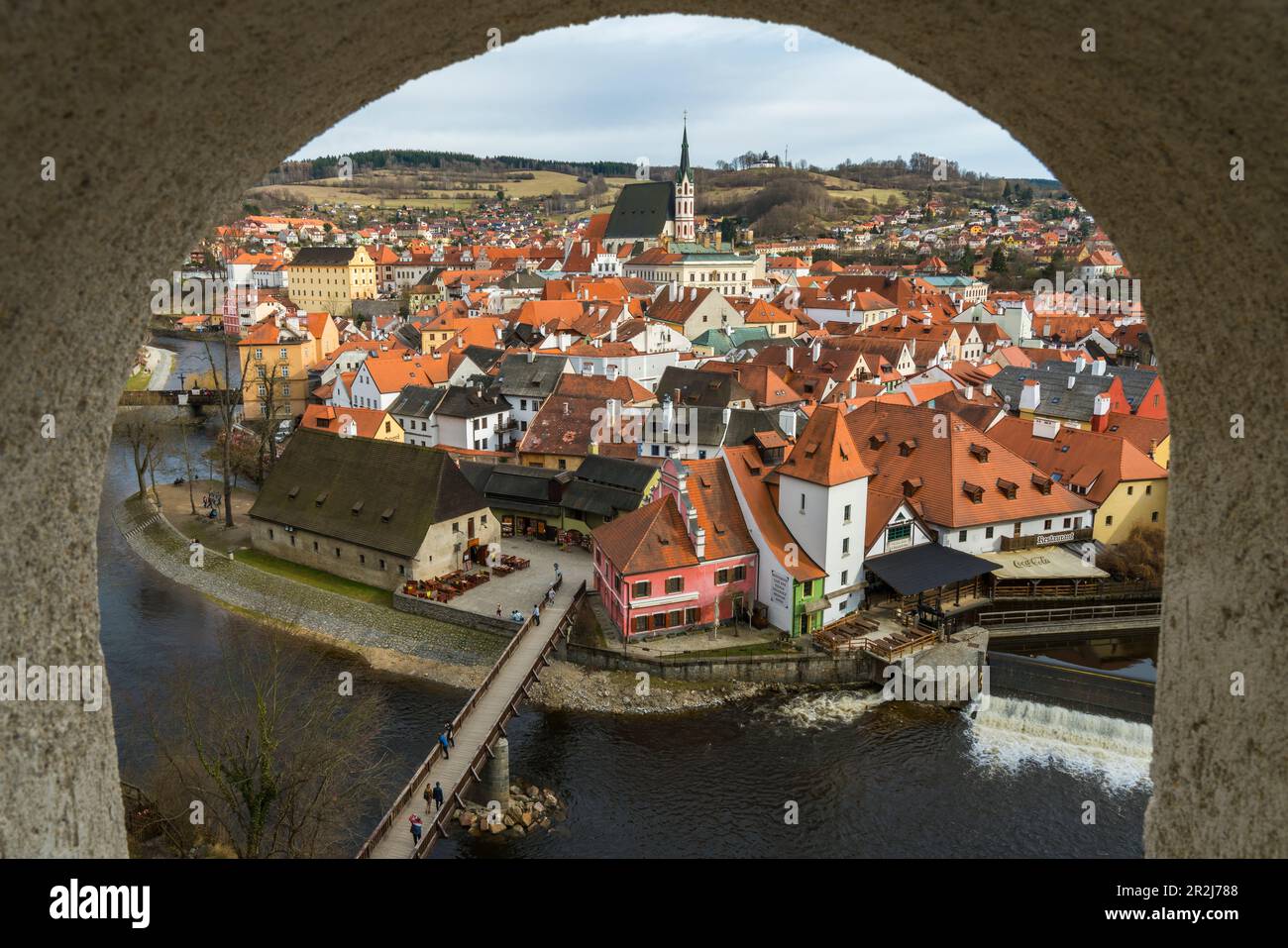 Historic town of Cesky Krumlov and Cesky Krumlov Castle Tower framed by window on Cloak bridge ...