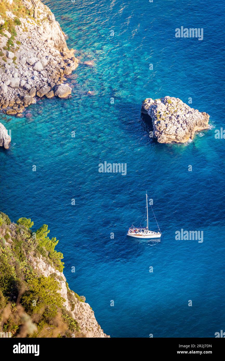 Sailboat in blue bay at the Faraglione Rocks on Capri, Capri Island ...