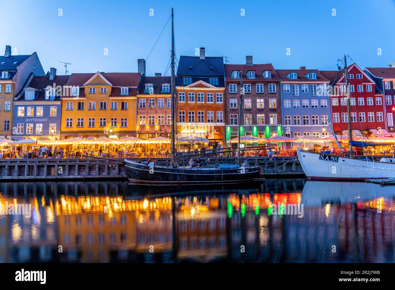 Colorful houses, restaurants and historic ships at Nyhavn canal and ...