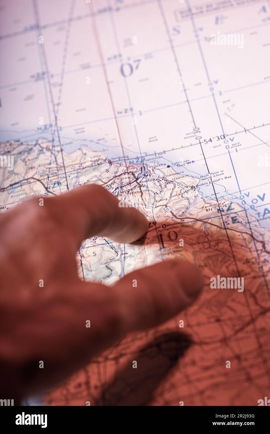 Finger ppointing at point on aerial map Stock Photo - Alamy