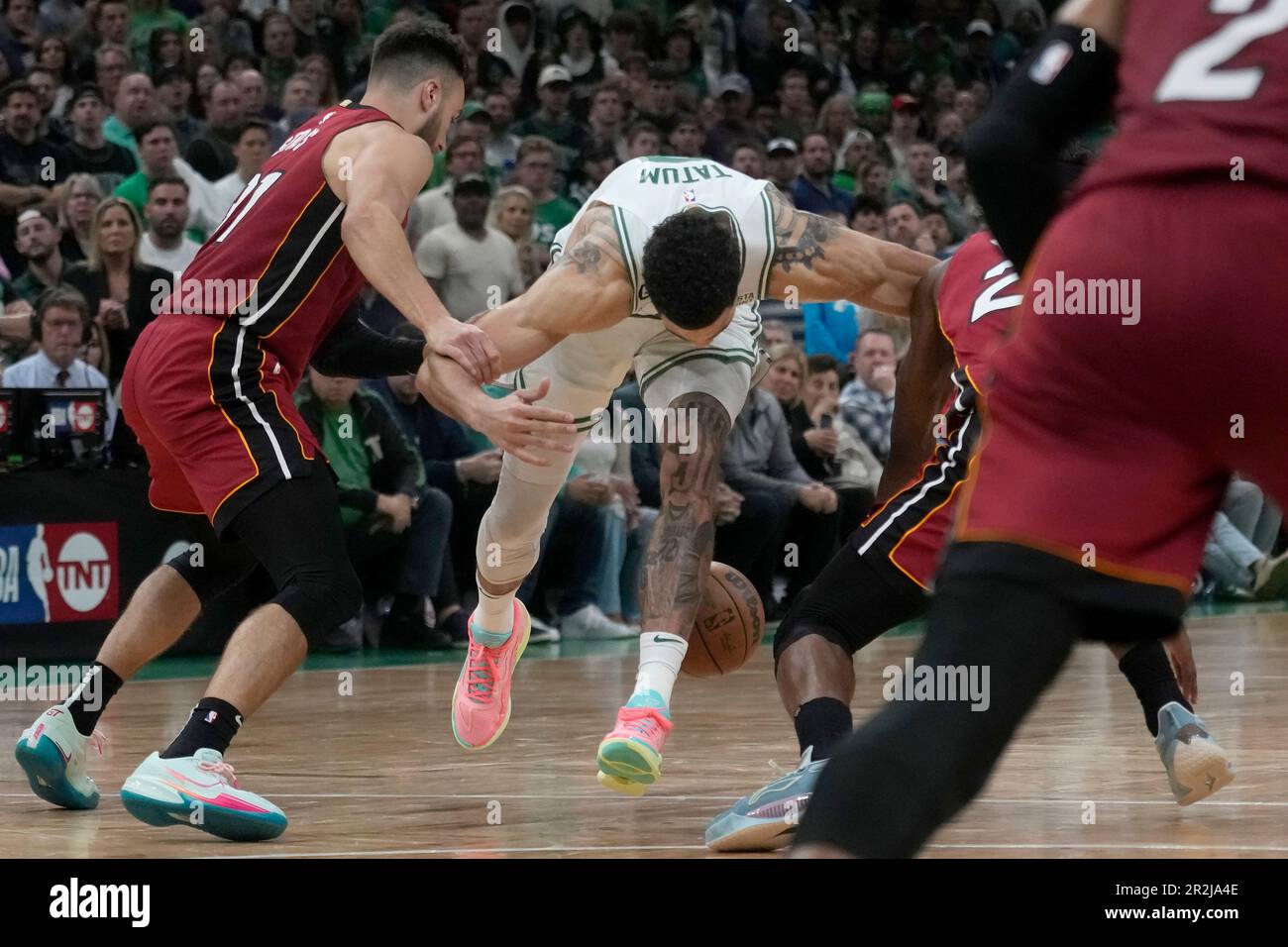 Boston Celtics forward Jayson Tatum, center, loses the ball between ...