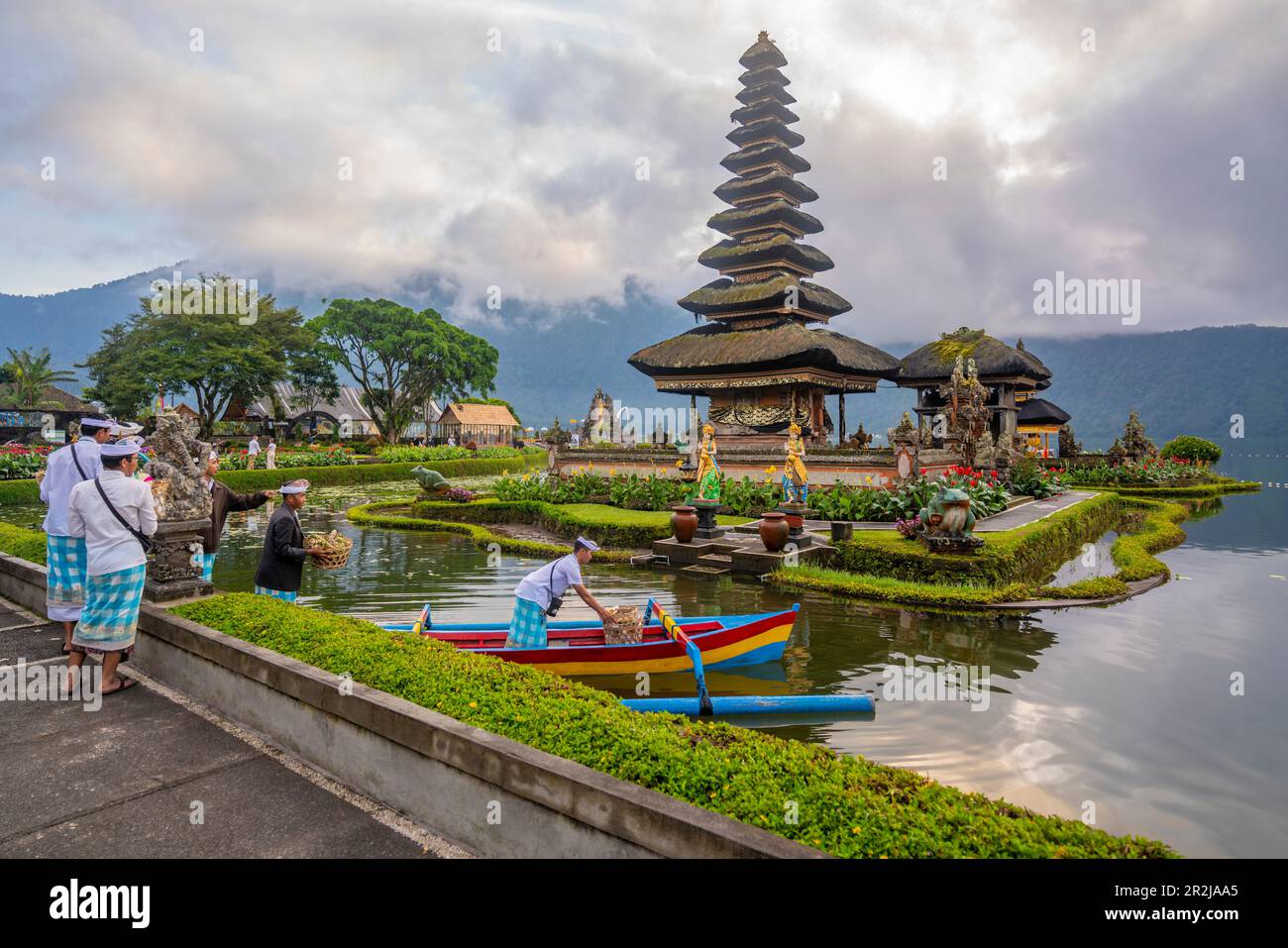 View of offerings being made at Ulun Danu Beratan temple on Lake Bratan ...