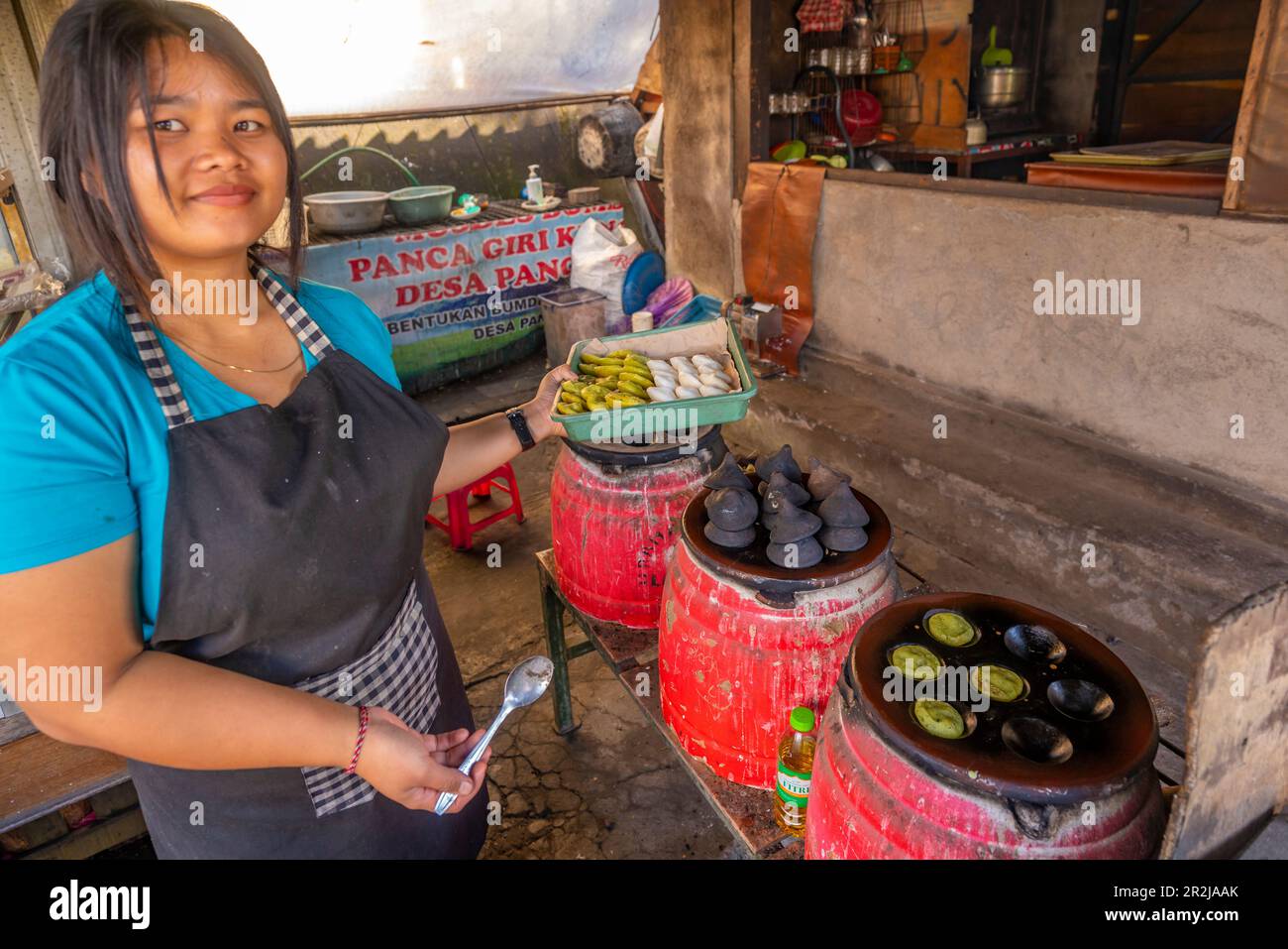 Girl making Klepon, traditional Balinese rice cakes, Bali, Indonesia ...