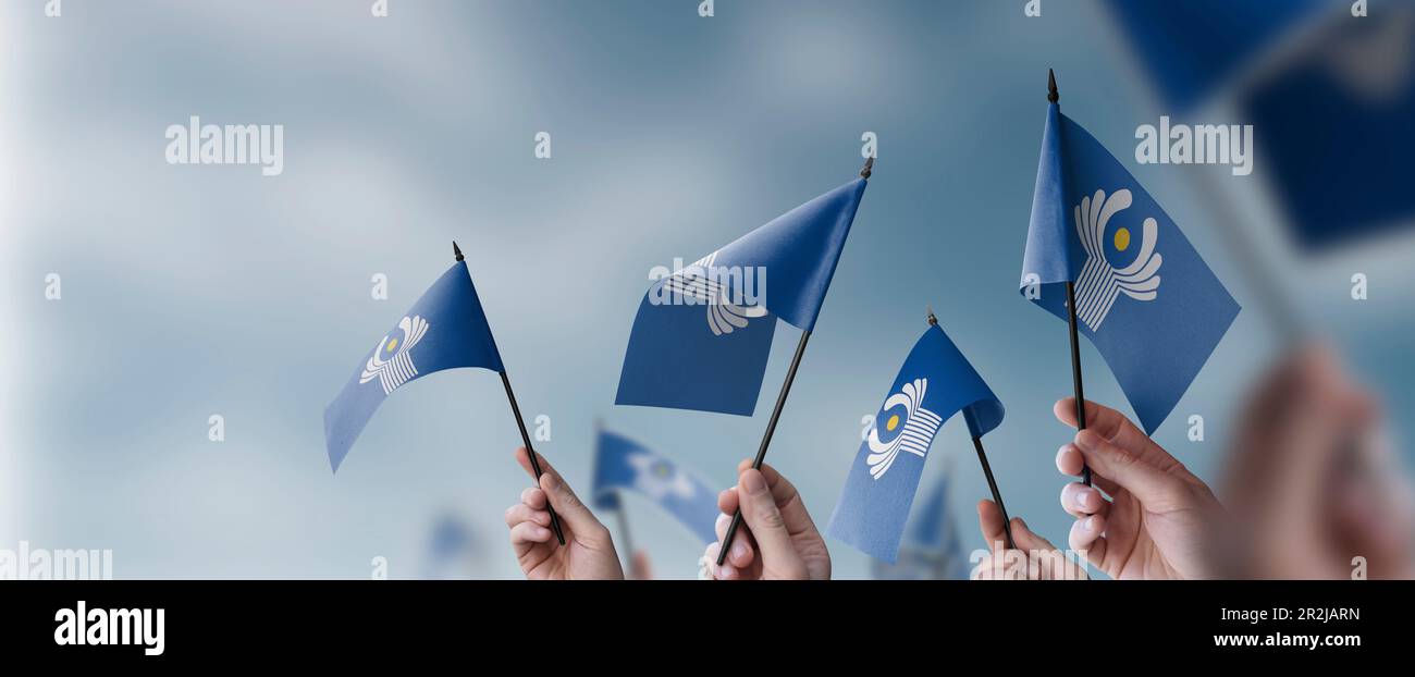 A group of people holding small flags of the CIS in their hands Stock ...