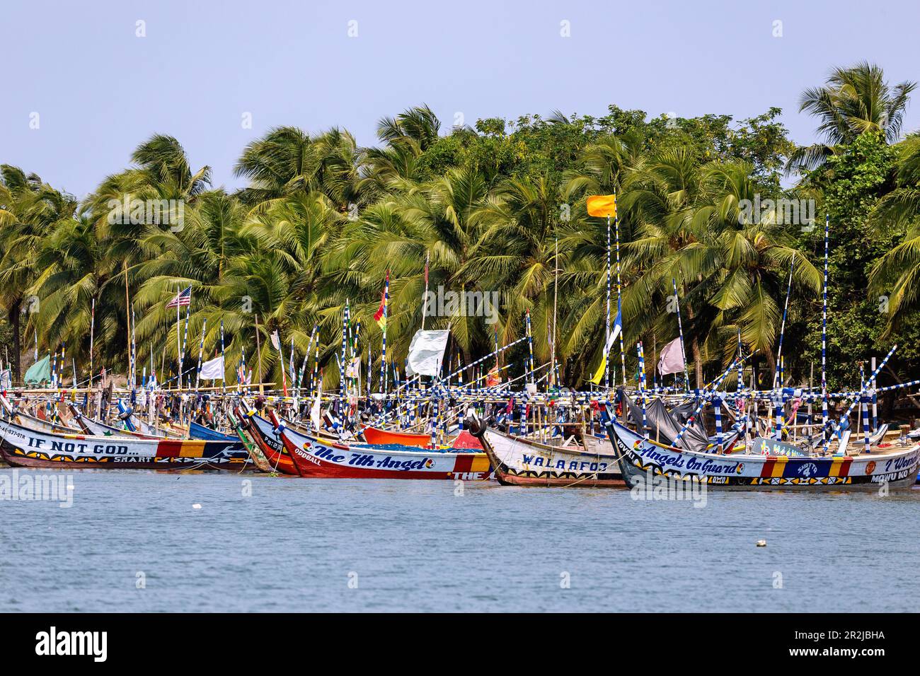 Fishing village of Ada Foah with brightly painted boats on the banks of ...
