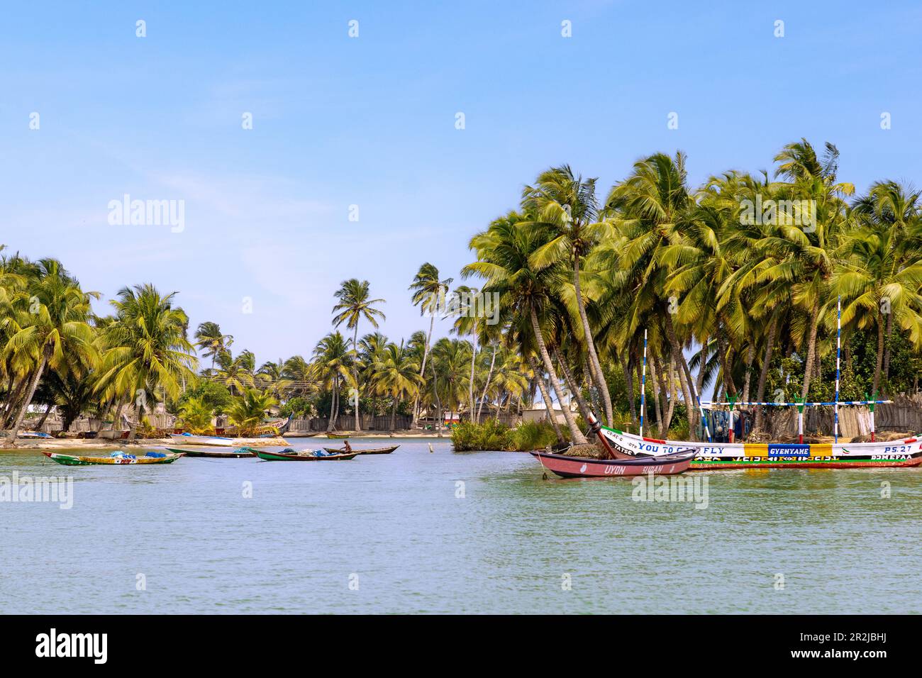 Fishing village of Ada Foah with brightly painted boats on the banks of ...